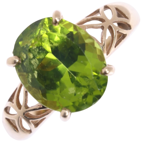 A 9ct gold single stone peridot ring, Gems TV, claw set with oval mixed ...
