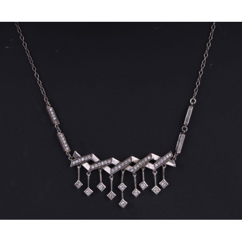A silver necklace with a nine drop white stone set pendant.