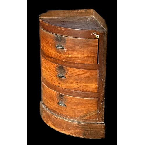 A bowfronted corner chest with three long drawers, on a plinth base ...