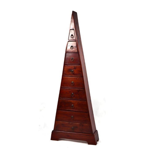 A modern pyramid shaped chest of drawers with an arrangement of nine ...