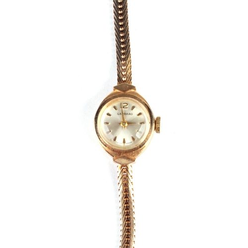 A 9ct gold cased Garrard & Co. ladies wristwatch on a 9ct gold strap ...