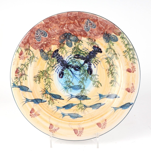 A Poole Pottery plate with stylised peacock feather design, 27cm ...