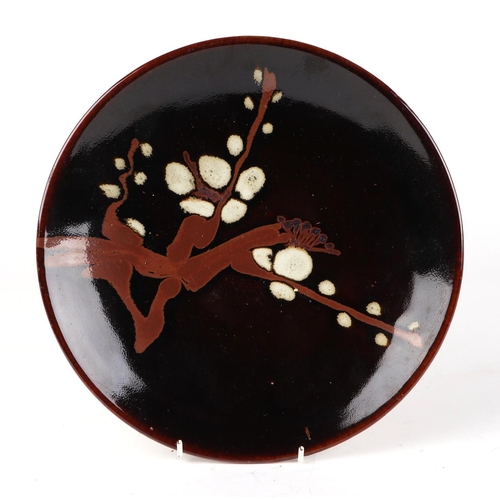 A Poole Pottery plate with stylised peacock feather design, 27cm ...