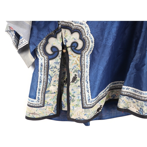 A Chinese silk embroidered robe with embroidered collars and cuffs on a ...