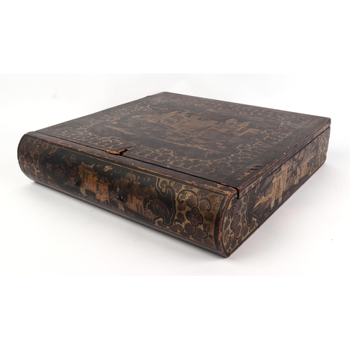 A Chinese lacquer writing box decorated with gilded figures on a black ...
