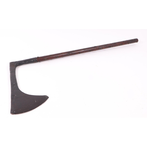 A large two-handled executioner's axe with large iron blade and studded ...