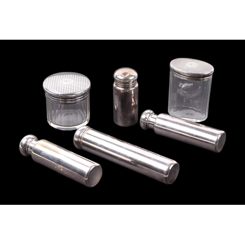 A group of four silver topped silver plated cosmetic jars; together ...