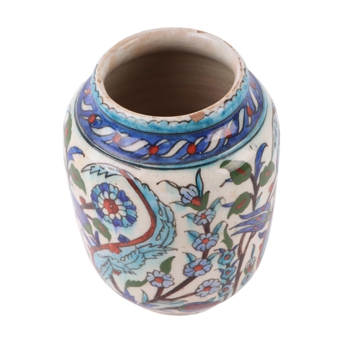 A Palestine / Iznik pottery vase decorated with flowers, 18cms high.