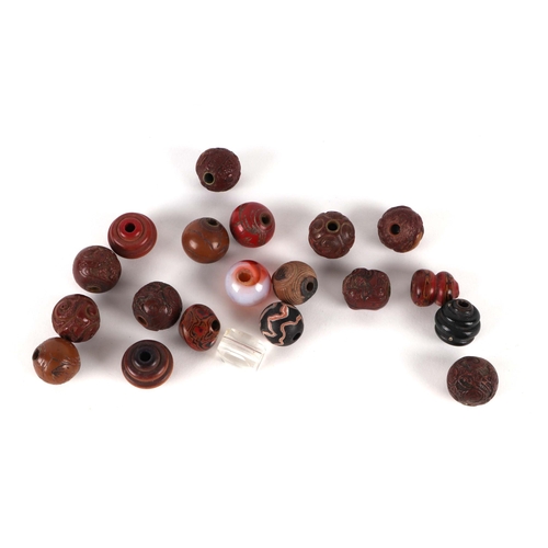 A collection of twenty Japanese Ojime beads to include stone, lacquer ...