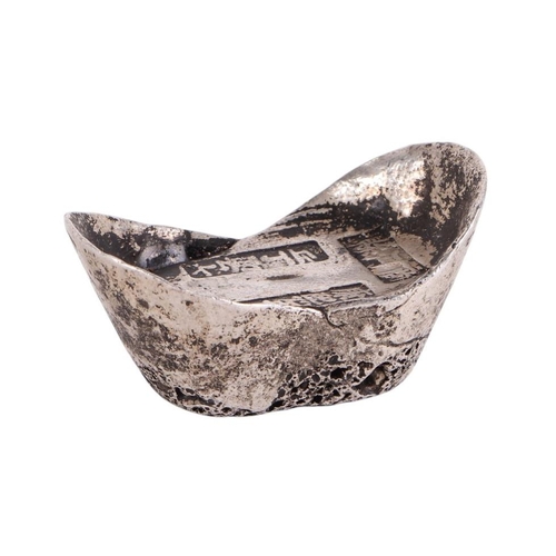 A Chinese white metal Sycee ingot, 149g.