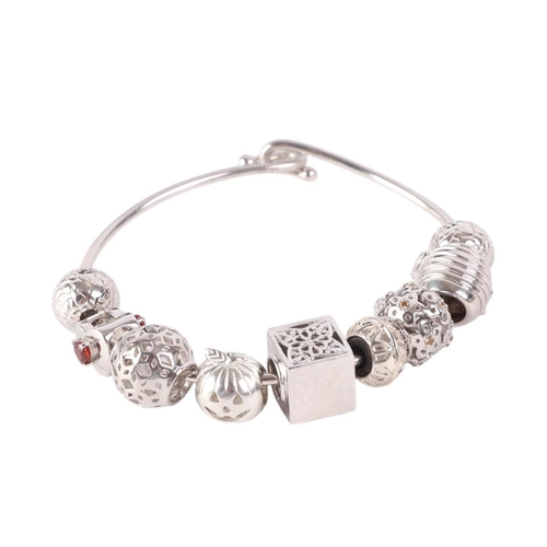 A 925 silver charm bracelet with nine silver charms, 37g.