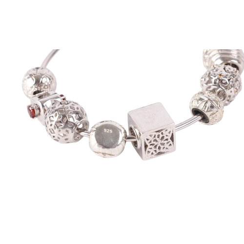 A 925 silver charm bracelet with nine silver charms, 37g.