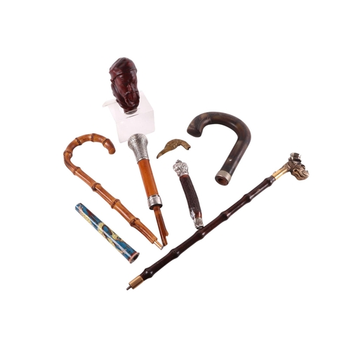 A novelty parasol handle in the form of a dog's head; together with a ...