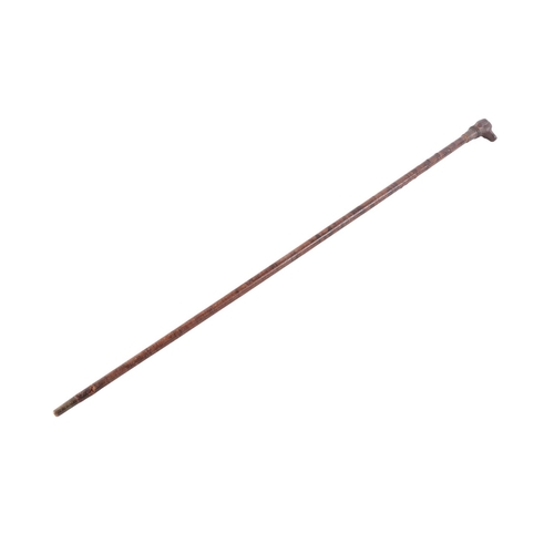A Dog head skull crusher walking cane covered in leather washers, with ...