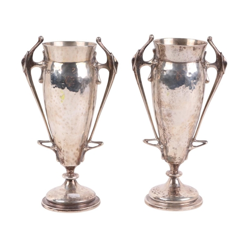 A pair of Arts & Crafts silver twin-handled vases, London 1905 and ...