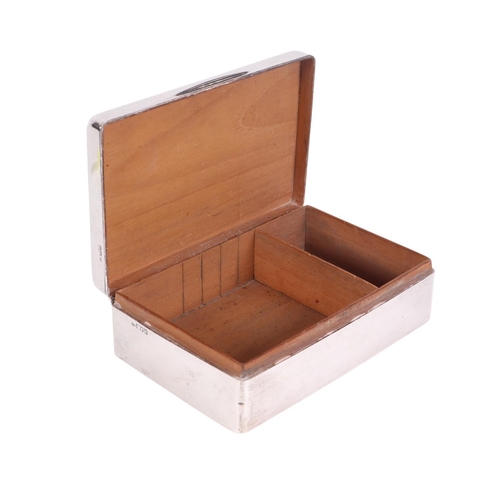 A large silver tabletop cigarette box, London 1903, 21cms wide.