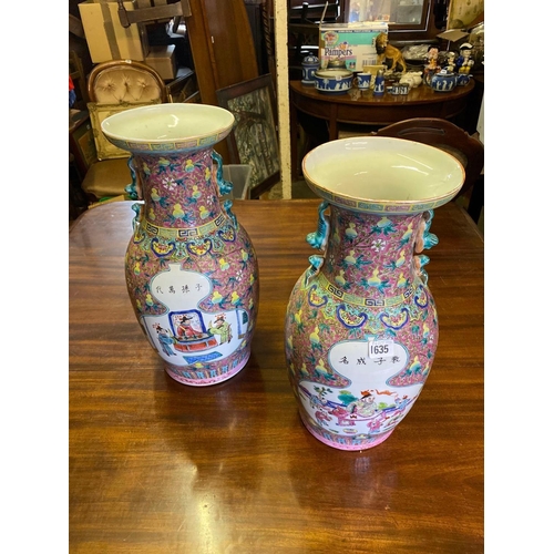 A large pair of decorative Canton vases enamelled with figures within ...