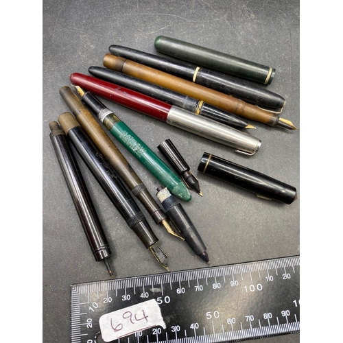 A bag of assorted fountain pen parts for spares