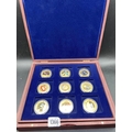 A boxed set of 9 proof Apollo Missions gold plated coins 2020 COA