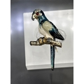 A metal parrot brooch with distressed enamel plumage