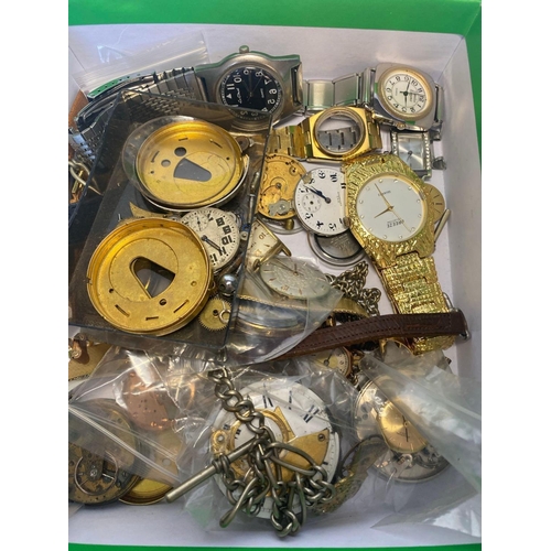A large box of assorted watches parts and movements