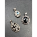 Three stone set silver pendants