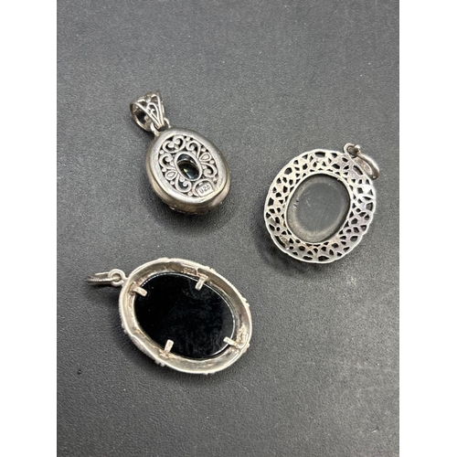 Three stone set silver pendants
