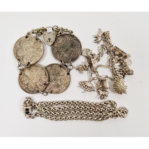 Sterling silver charm bracelet holding a silver charm and white metal ...