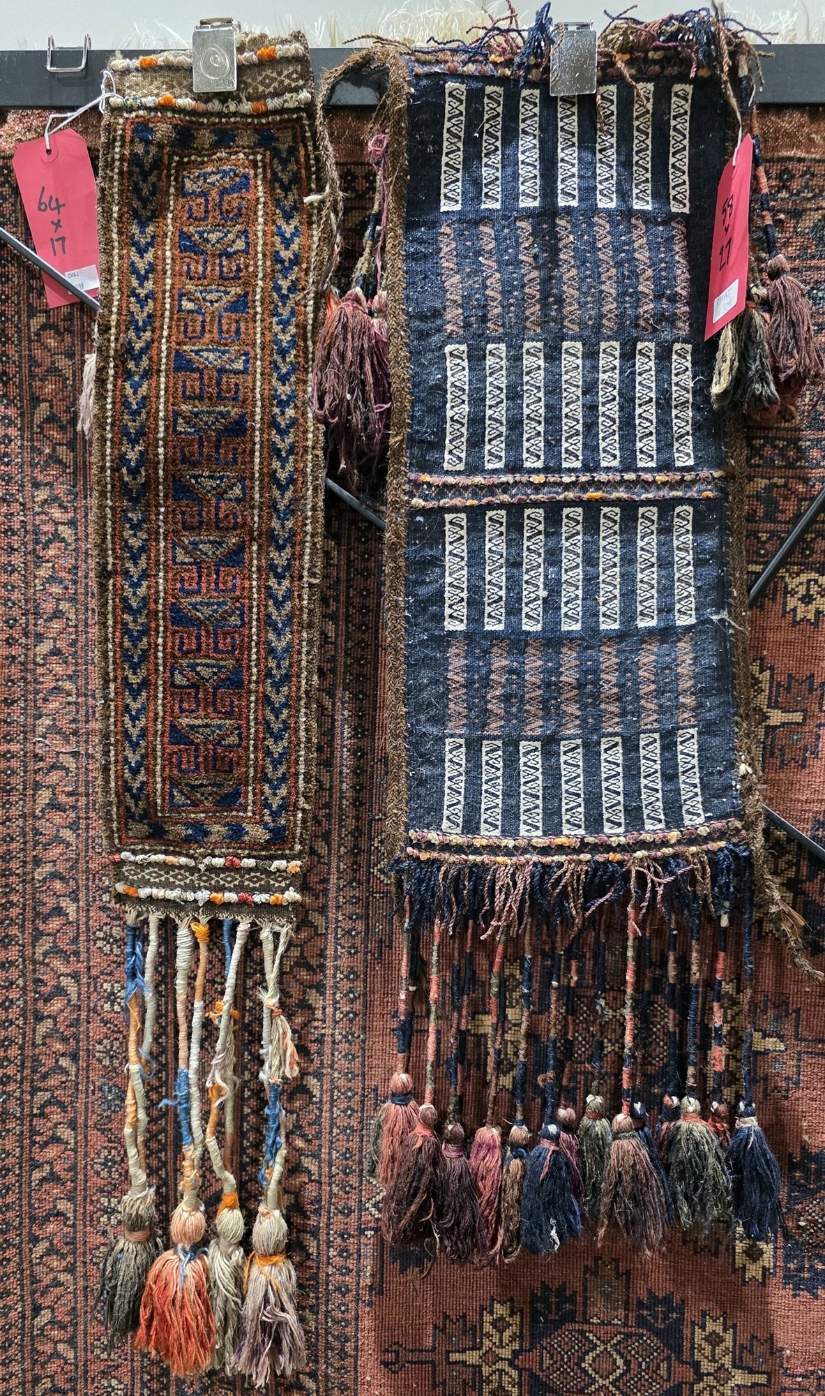 Two small rugs/wall hangings, one with geometric stripe pattern, 58cm x 27cm, the other with geometr