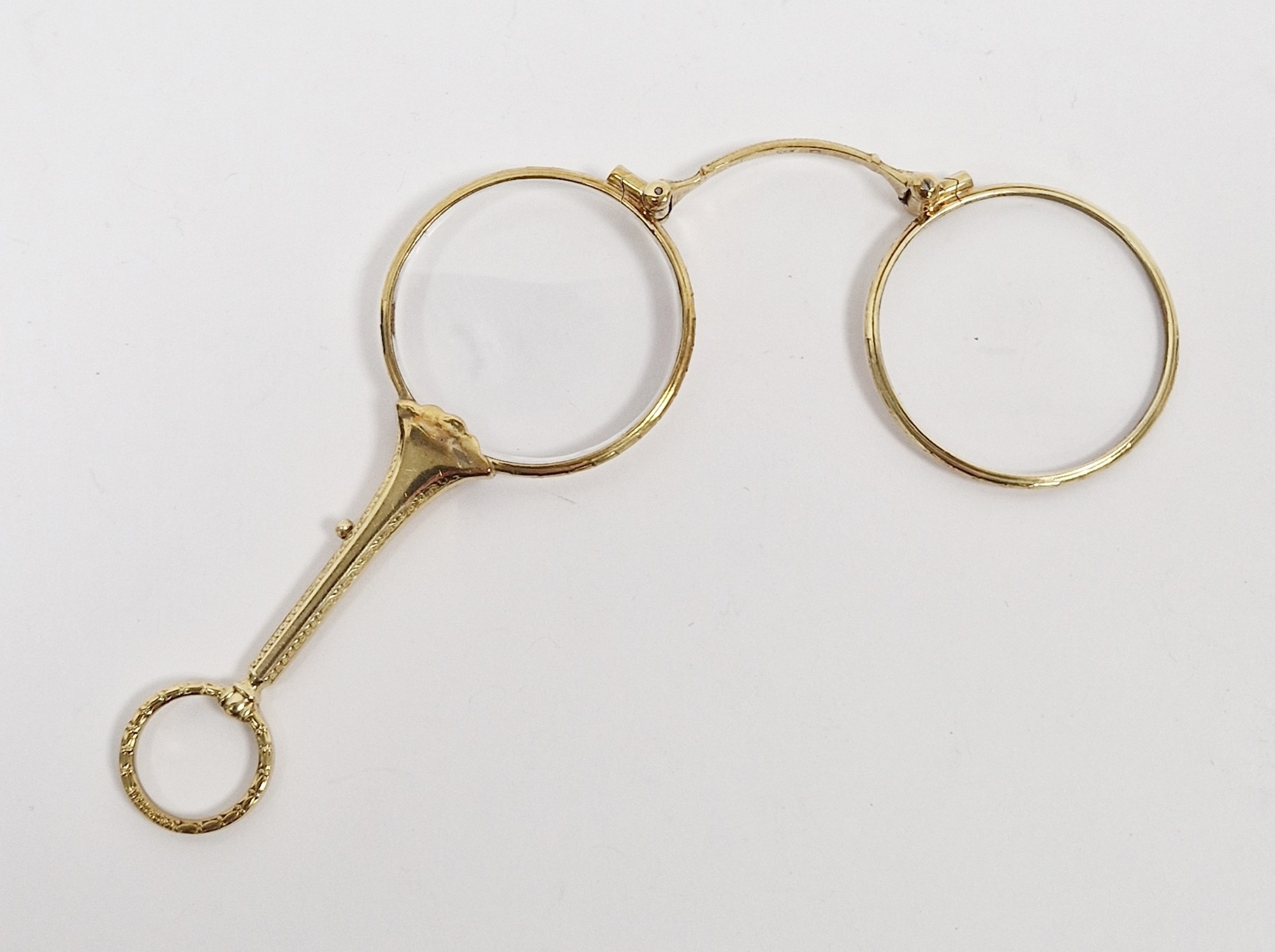 Pair of gold folding lorgnettes with circular lenses, engraved handle ...