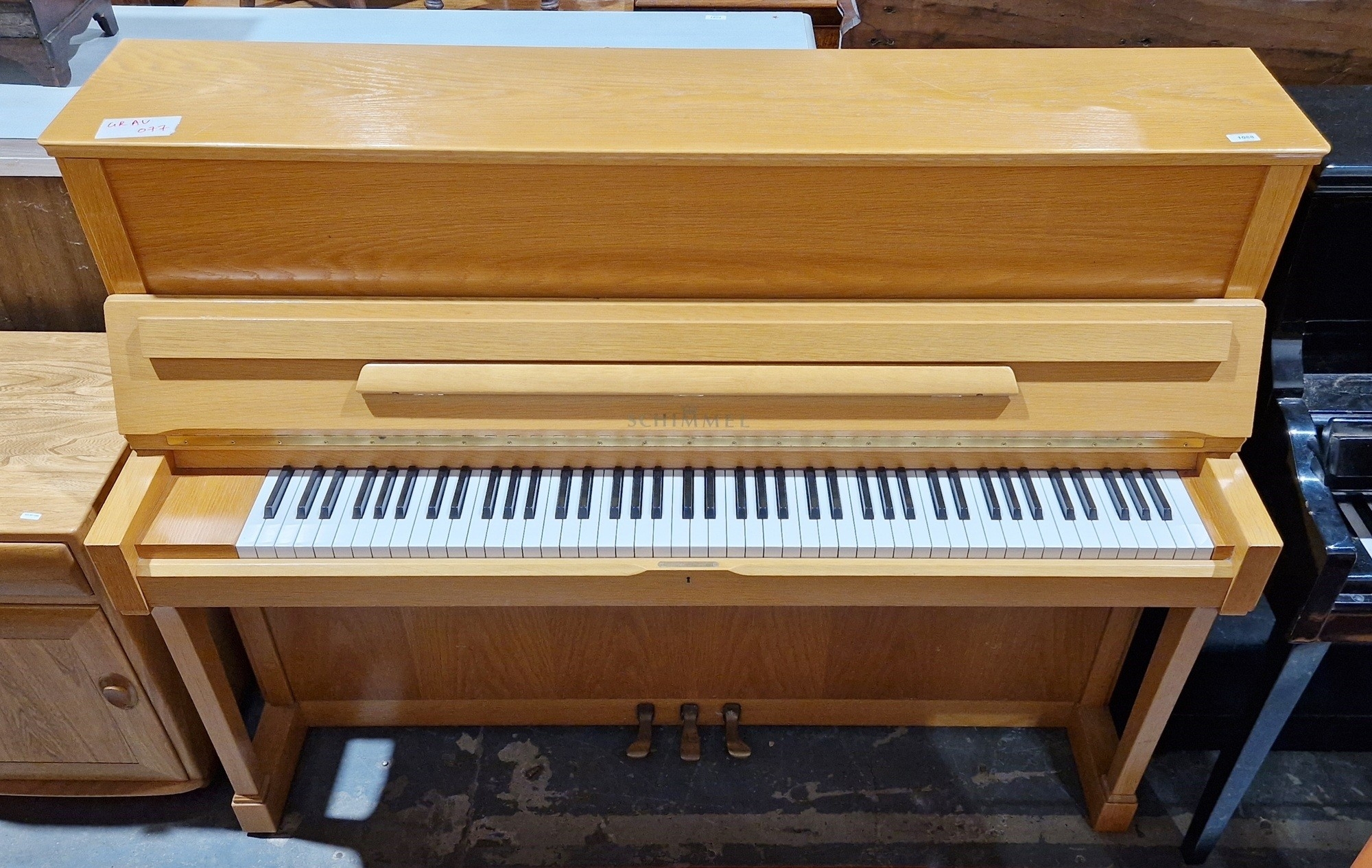Modern Schimmel upright piano housed in a pale oak case, model 118 ...