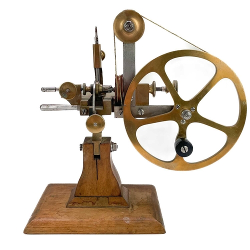 A watchmakers' brass and steel topping tool. Mounted on a walnut base ...