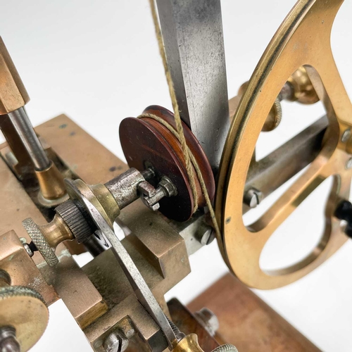 A watchmakers' brass and steel topping tool. Mounted on a walnut base ...