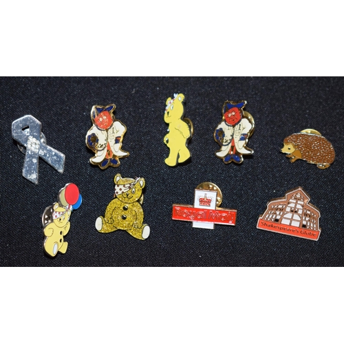A collection of pin badges to include Pudsey Bear, Royal Mail, a ...