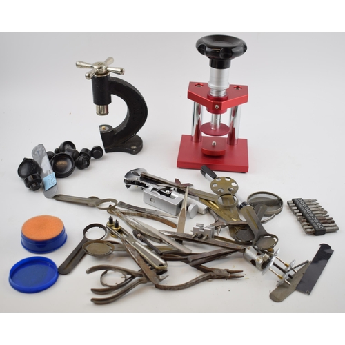 A collection of watchmaker hand tools and presses. Of note are some ...