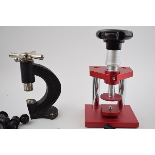 A collection of watchmaker hand tools and presses. Of note are some ...