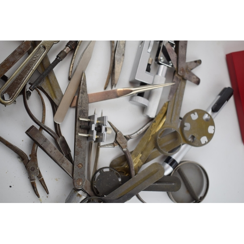 A collection of watchmaker hand tools and presses. Of note are some ...