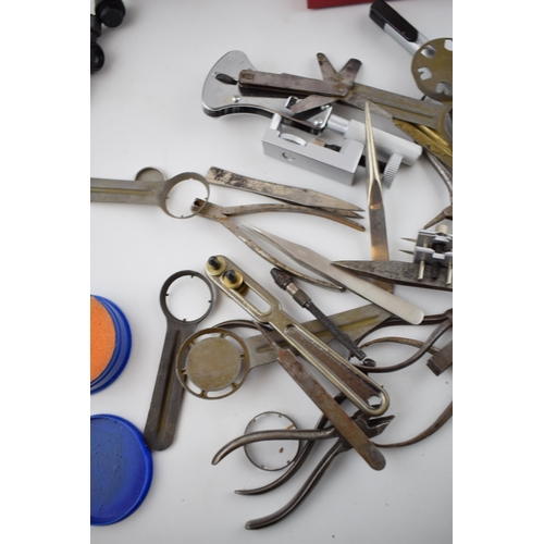 A collection of watchmaker hand tools and presses. Of note are some ...