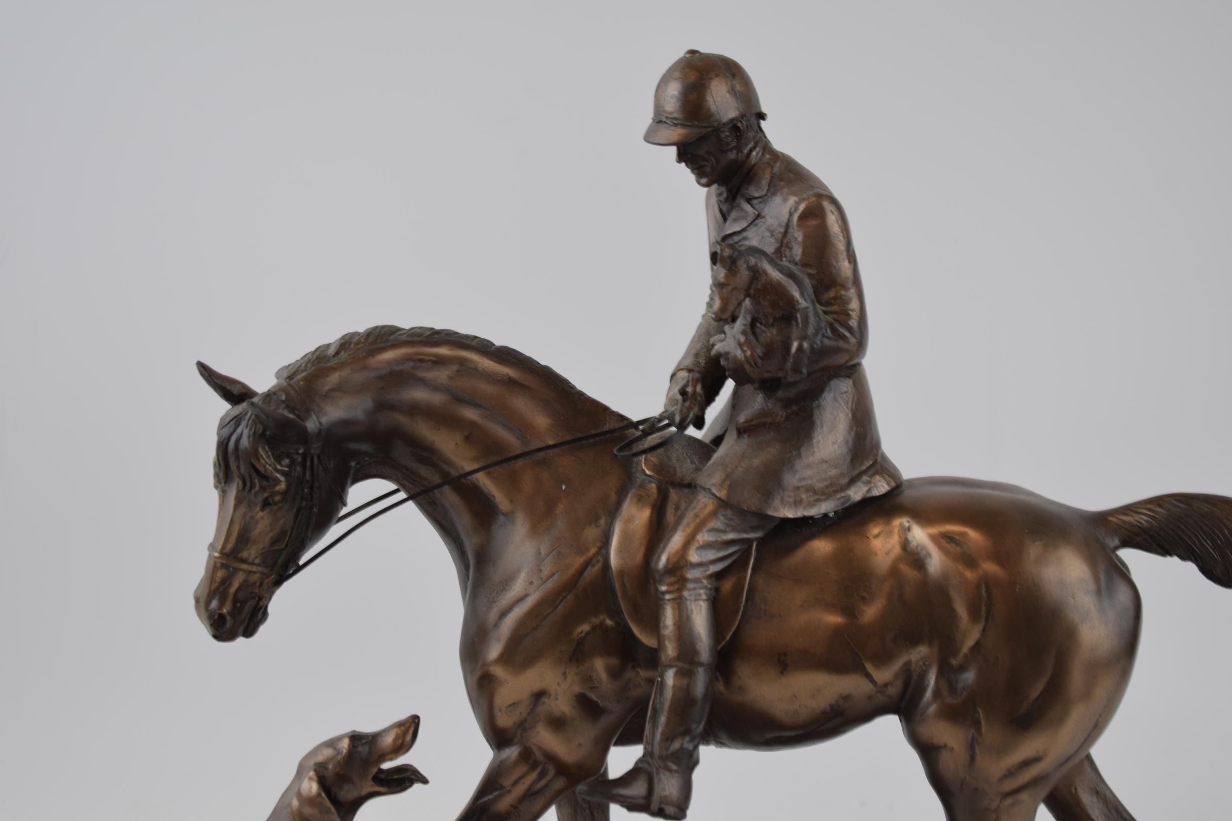 David Geenty: a bronzed resin huntsman scene on wooden base, 38cm wide.