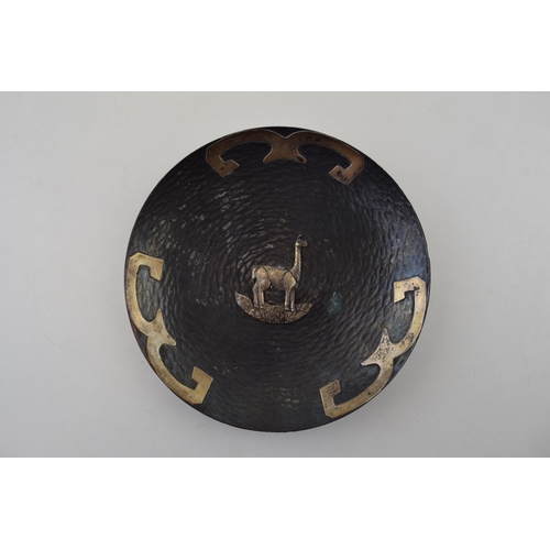 A hand chased concave wall plaque with a white metal Lama design to the ...