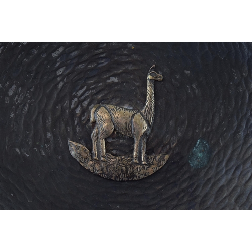 A hand chased concave wall plaque with a white metal Lama design to the ...