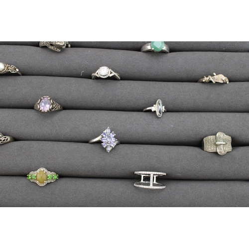 A collection of twenty-eight silver rings of varying sizes and designs ...