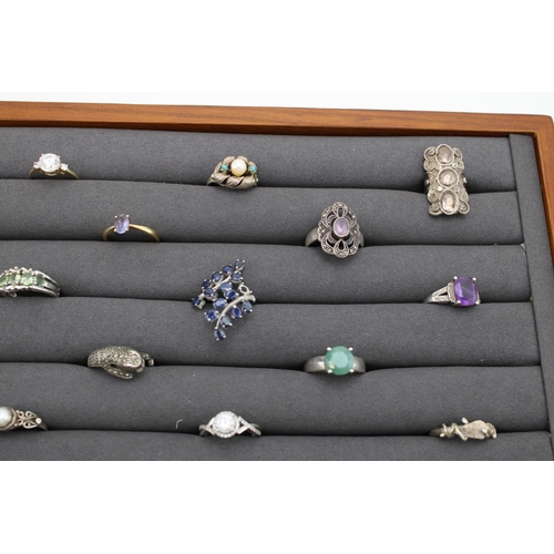 A collection of twenty-eight silver rings of varying sizes and designs ...