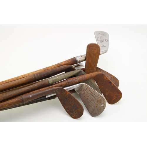 A collection of 10 early c20th antique hickory shaft golf clubs with ...