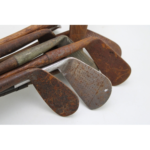 A collection of 10 early c20th antique hickory shaft golf clubs with ...