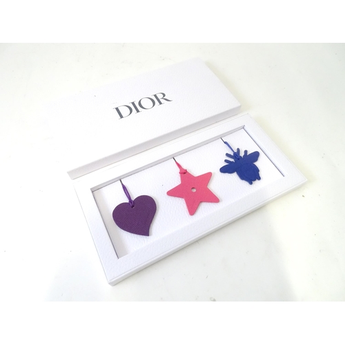 A boxed set of three Dior bag / luggage tags / charms