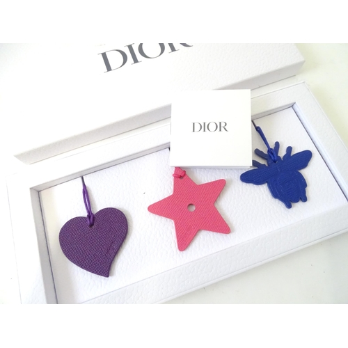 A boxed set of three Dior bag / luggage tags / charms