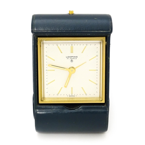 A Looping swiss made travelling alarm clock in green leather covered ...