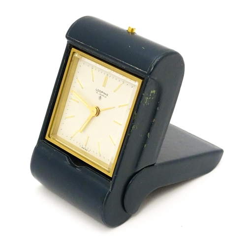A Looping swiss made travelling alarm clock in green leather covered ...