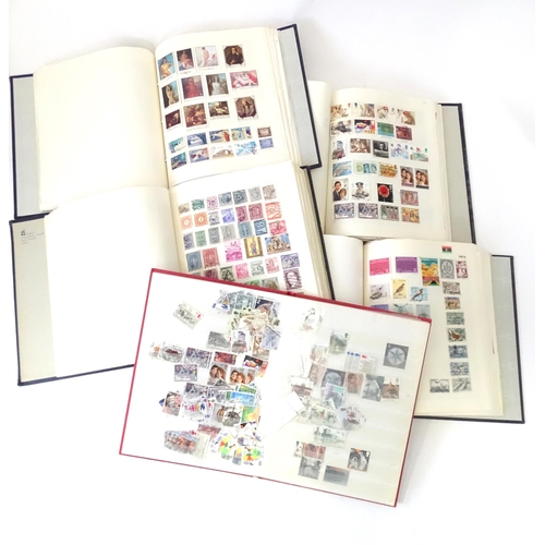 A quantity of 19th and 20thC postage stamps affixed within five albums ...